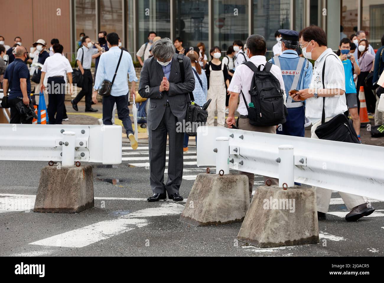 Nara, Nara, Japan. 9th July, 2022. A man wearing a face mask offers a ...
