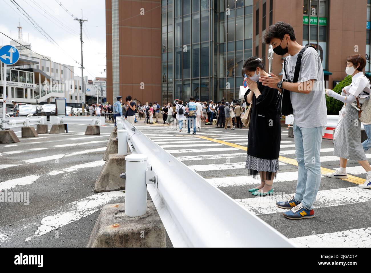 Nara, Nara, Japan. 9th July, 2022. People wearing face masks offer a ...