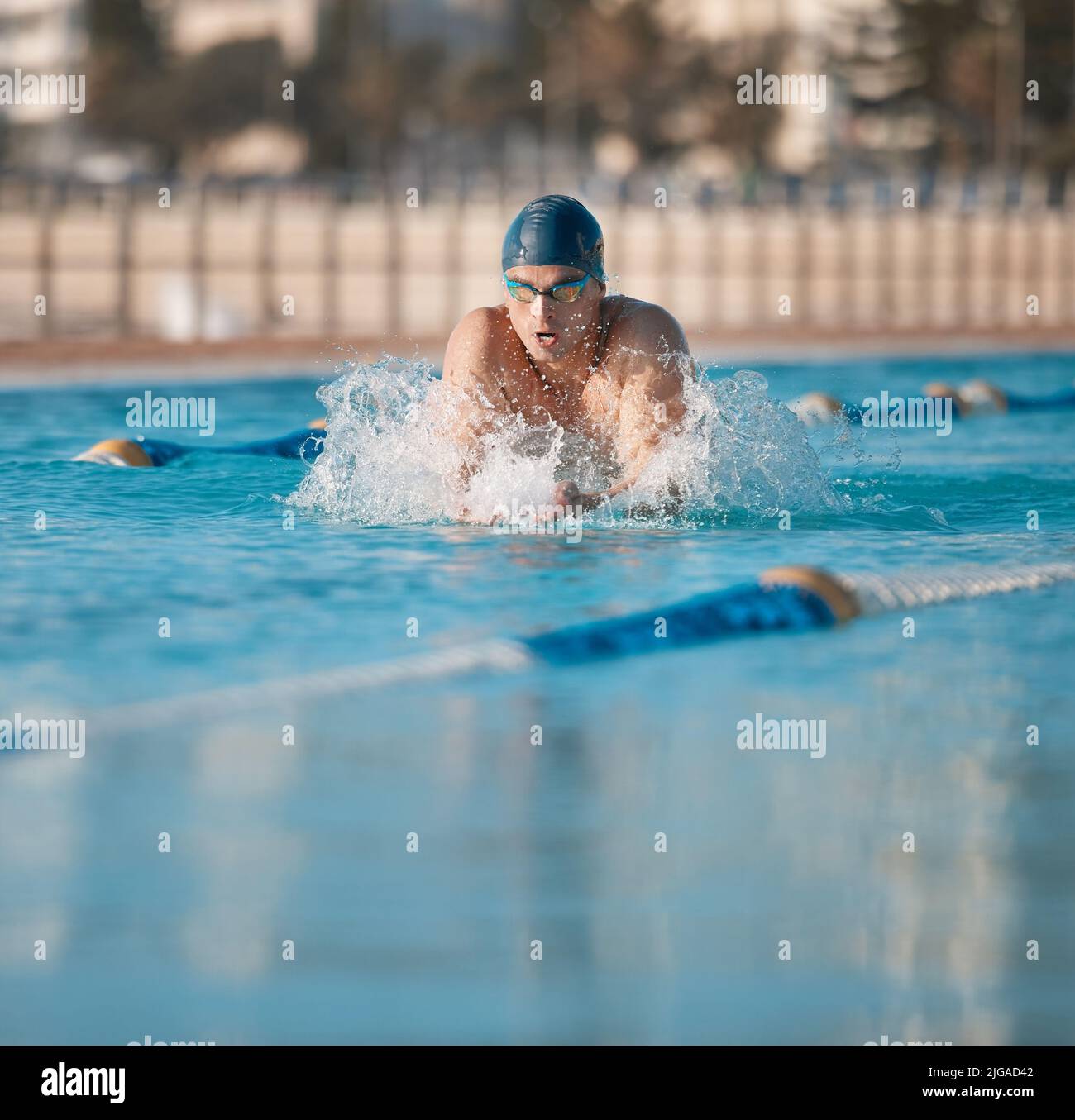 Hes taken to water like a fish. a handsome young male athlete swimming ...