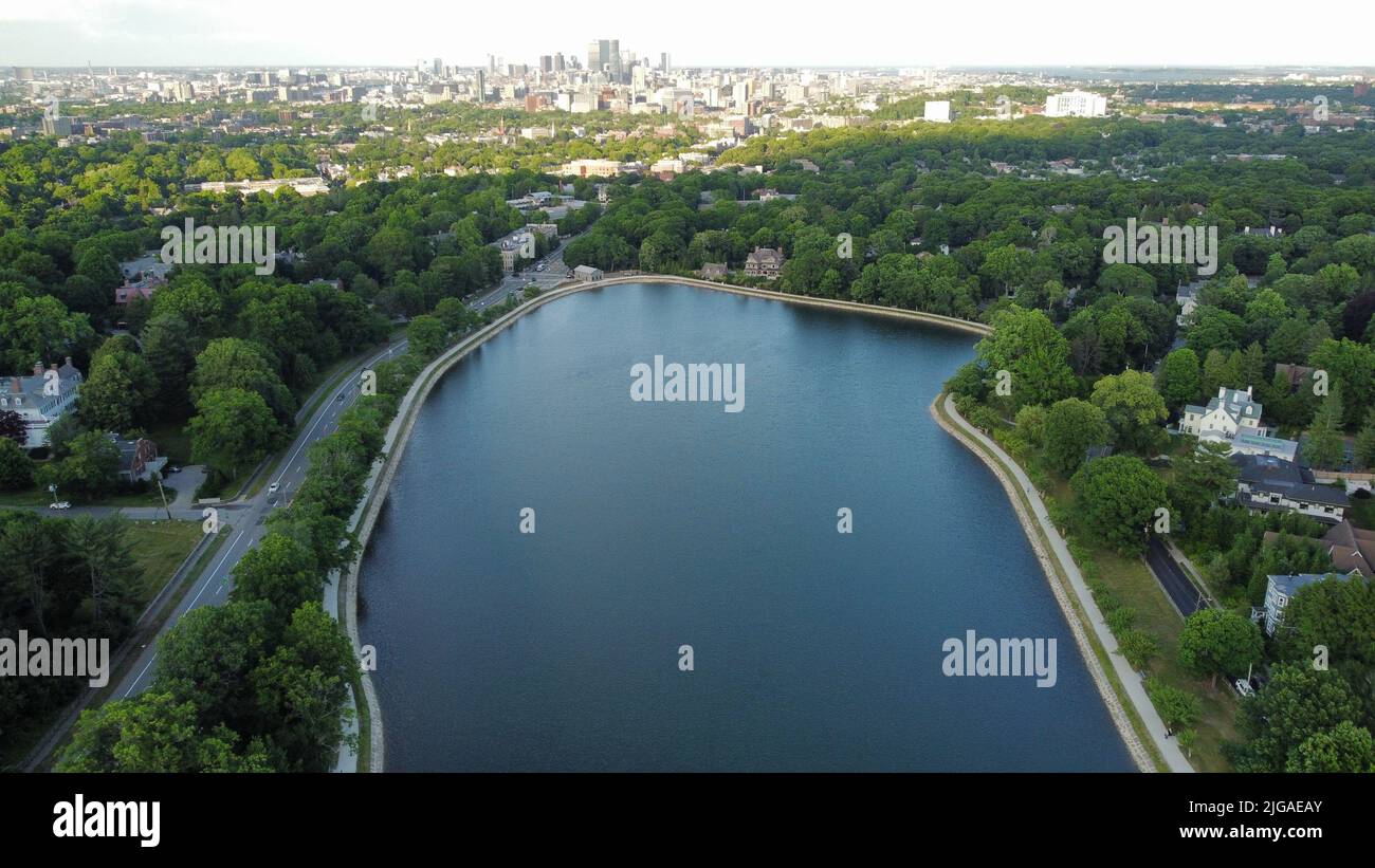 A scenic aerial view of a river among trees in green foliage with ...