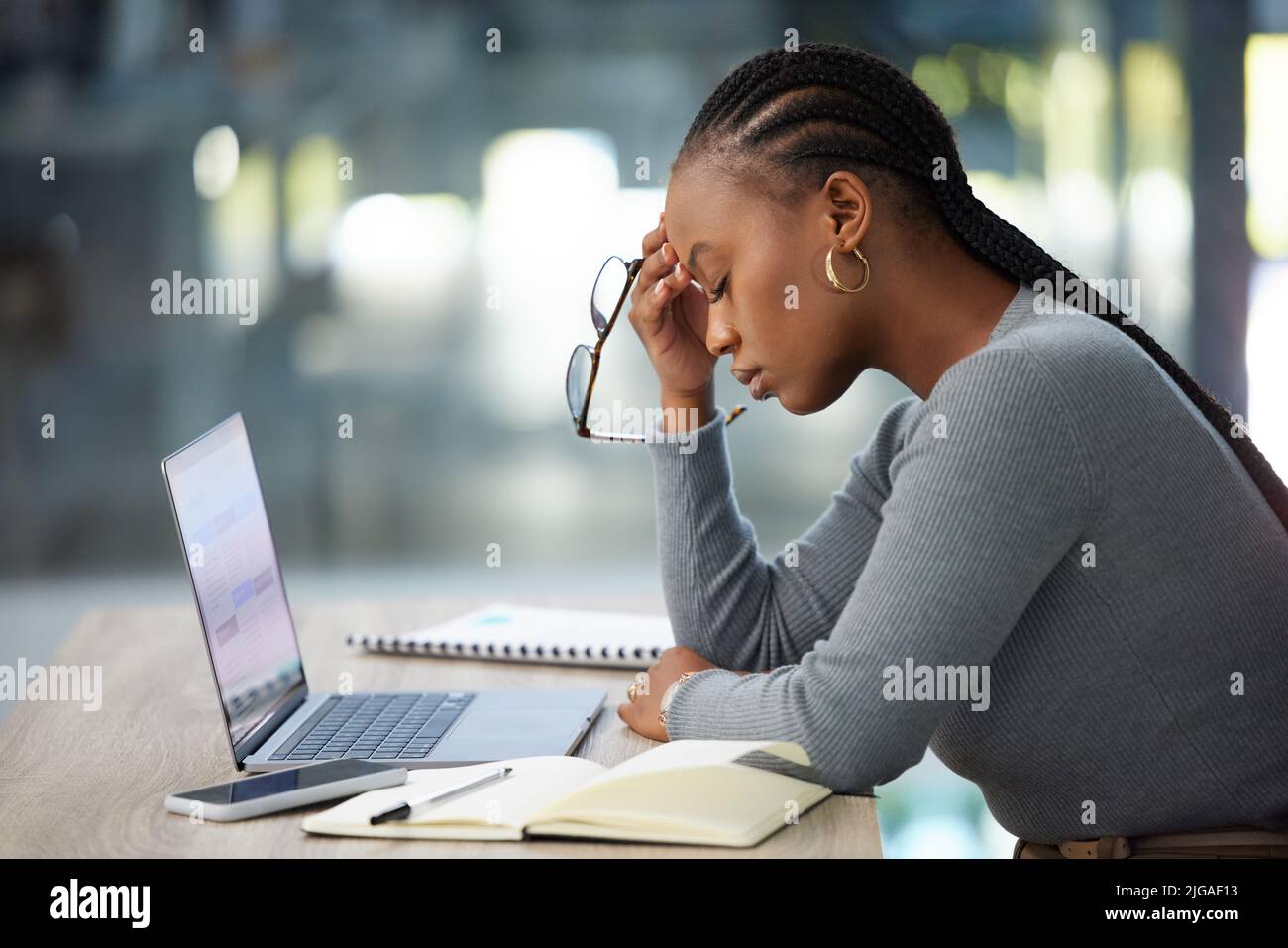 Its all become a little too much. a young businesswoman looking ...