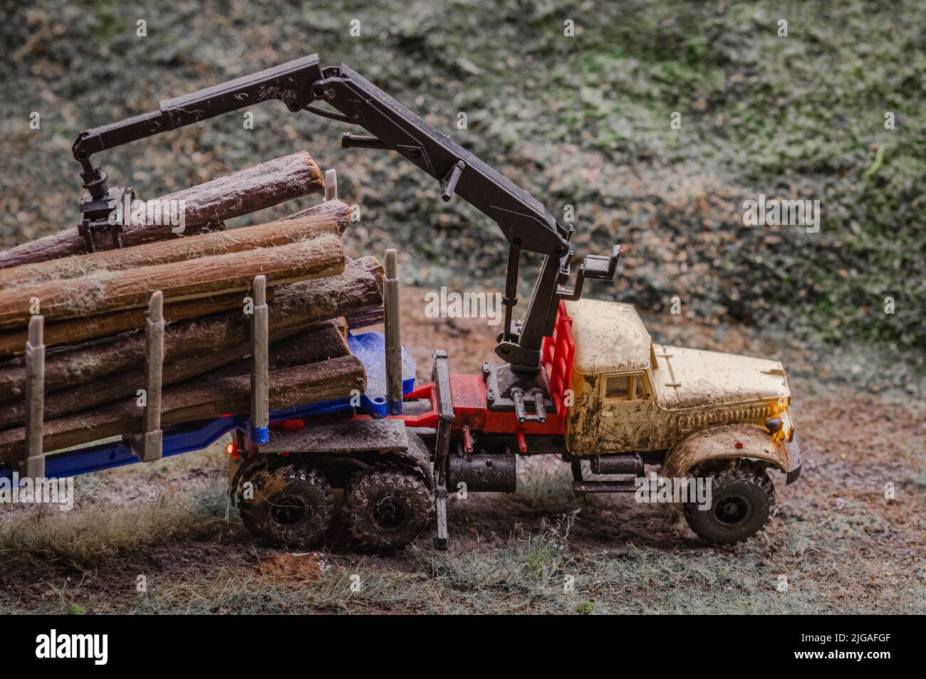Toy representation of a truck unloading tree trunks Stock Photo - Alamy