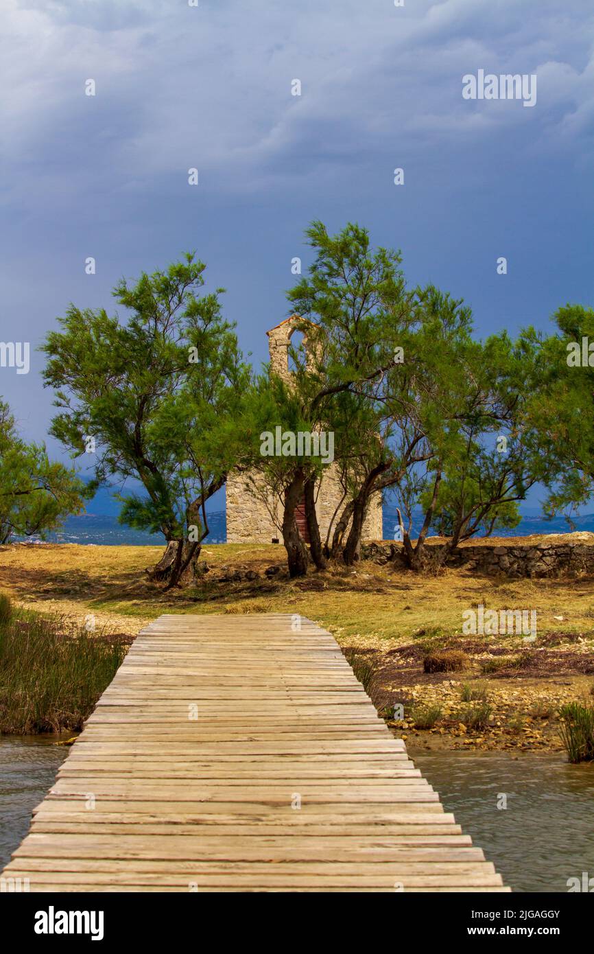Church on an island in front of mountains Stock Photo - Alamy