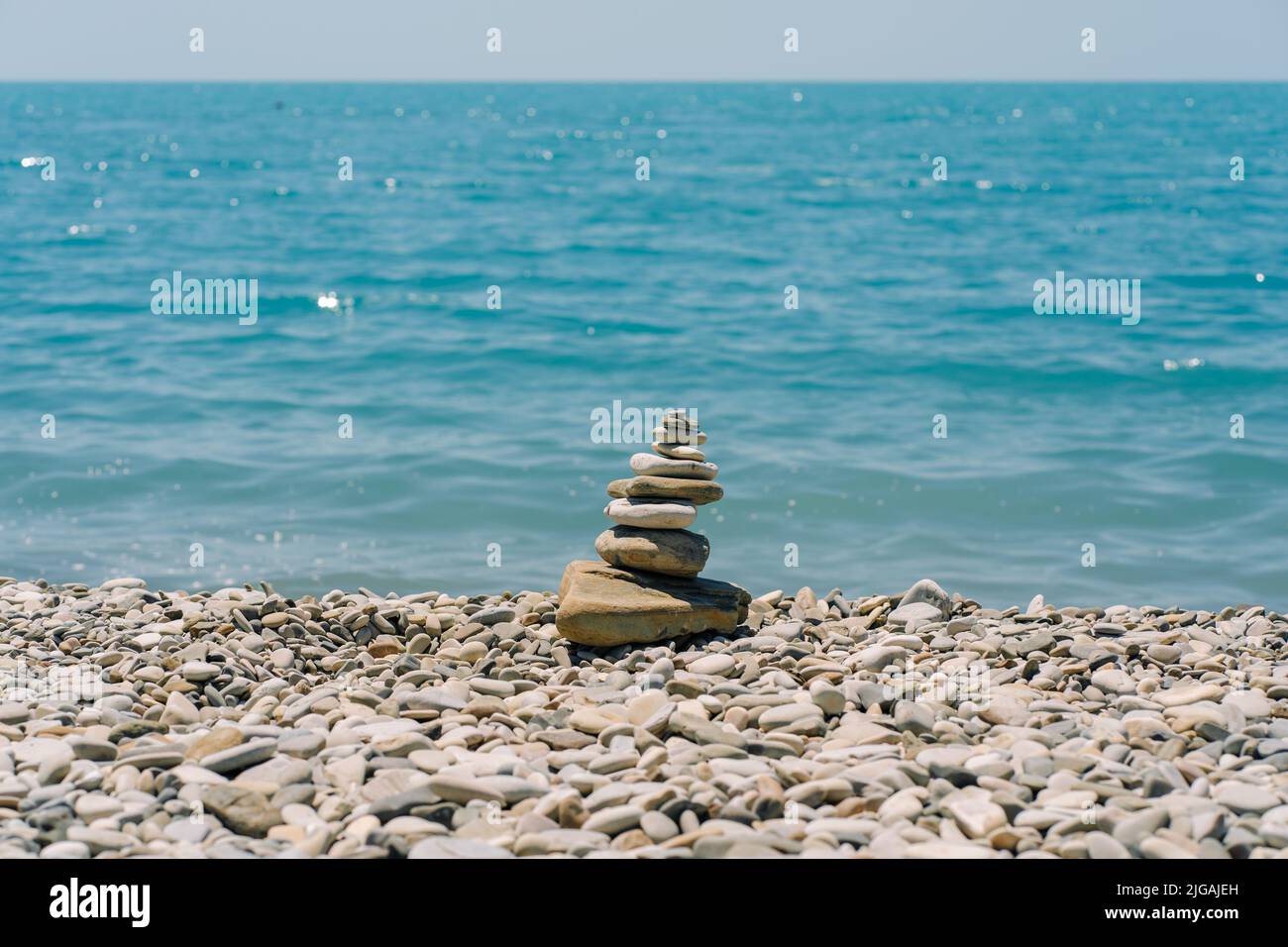 Balanced stones on a pebble beach. Sea stones arranged in a balance ...