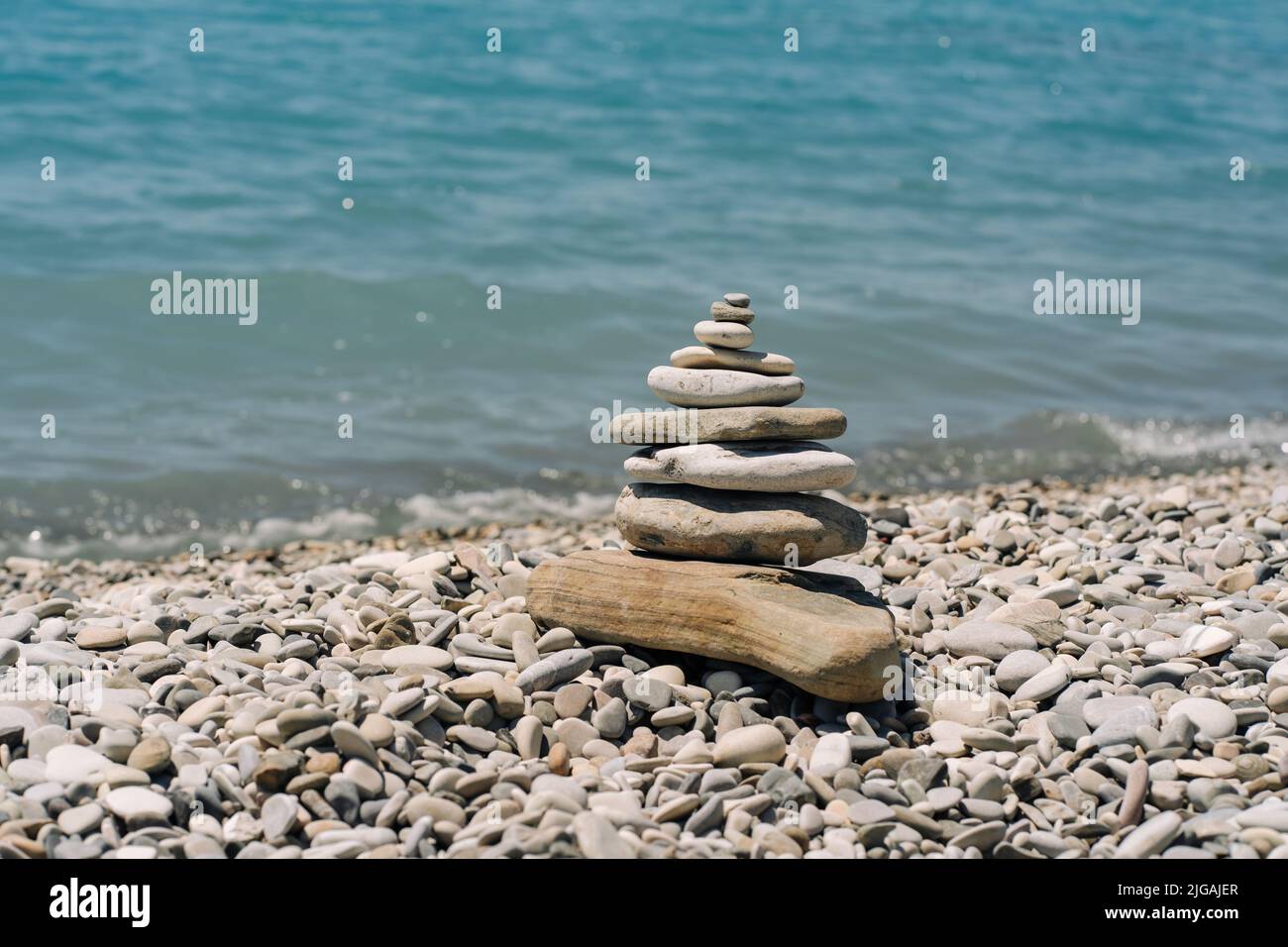 Balanced stones on a pebble beach. Sea stones arranged in a balance ...