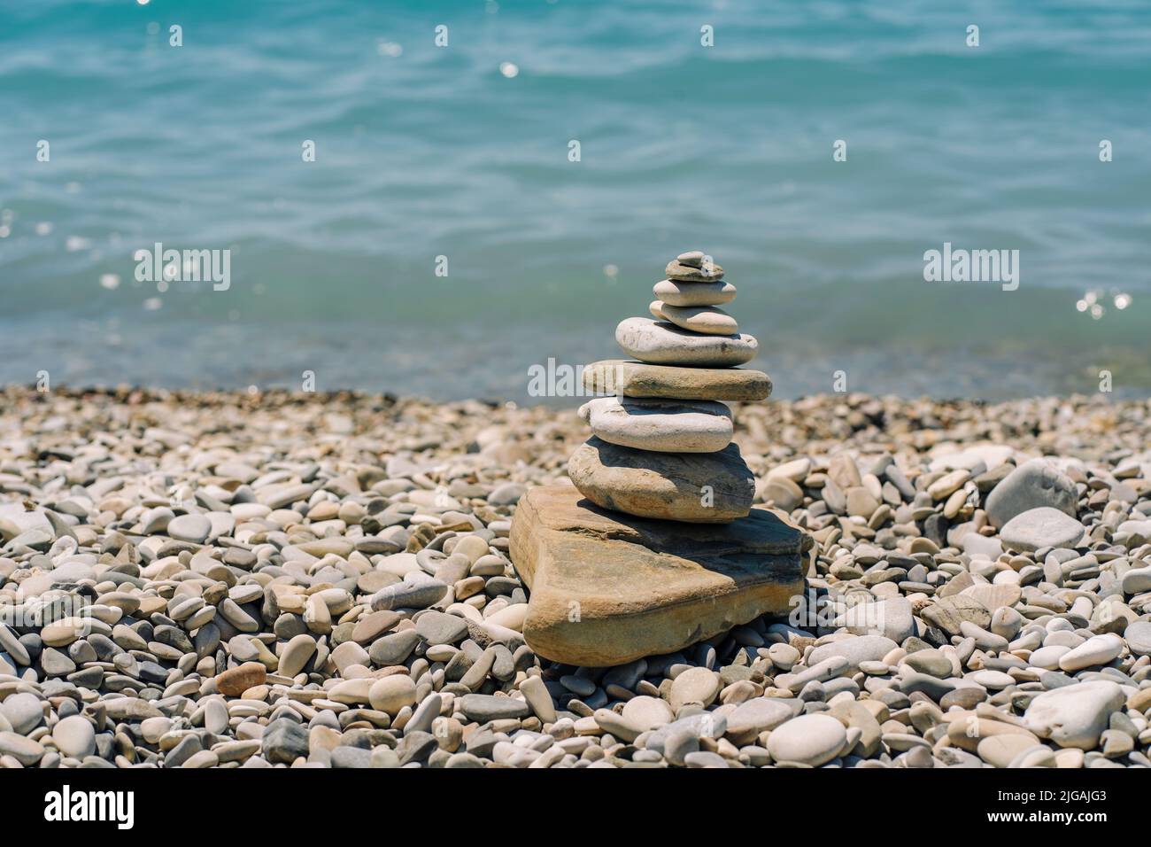 Balanced stones on a pebble beach. Sea stones arranged in a balance ...