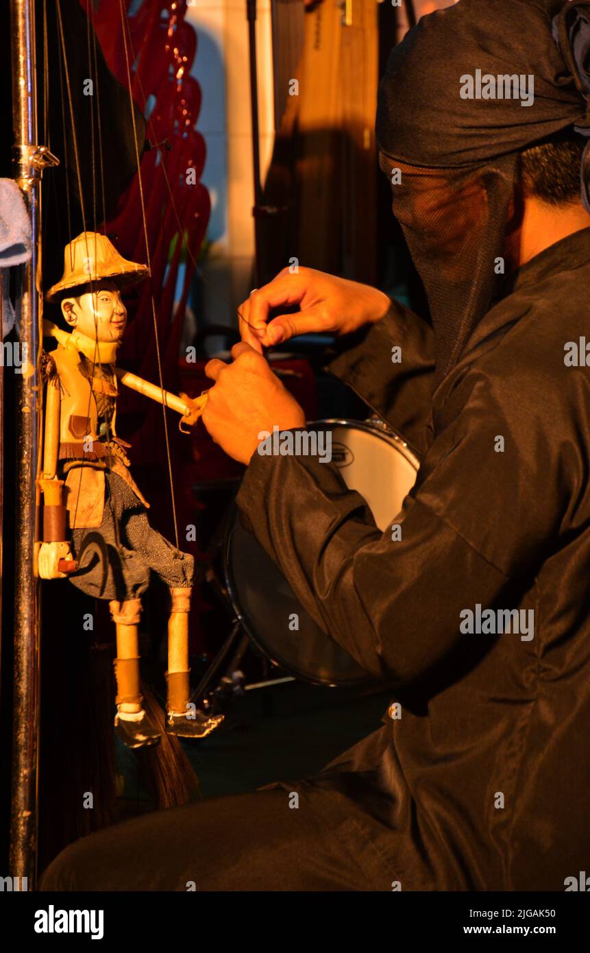 Thai professional puppeteer or Puppet master manipulate playing acting ...