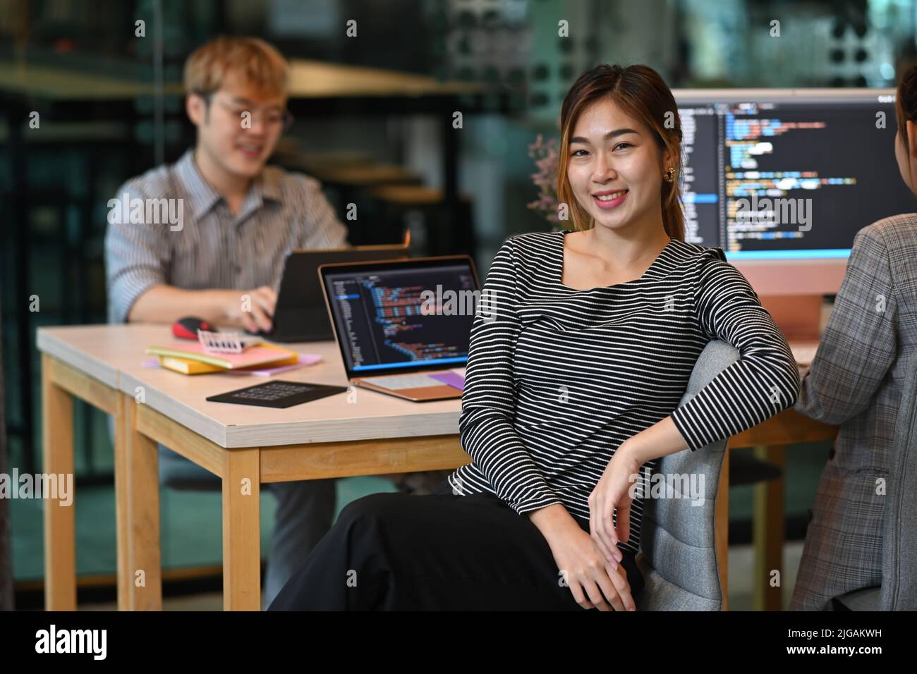 Confident young female professionals web developer sitting in software ...