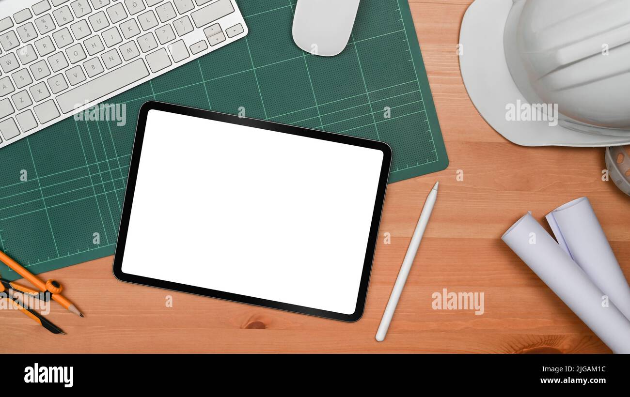 Architectural and Engineer office desk with digital tablet, helmet and ...