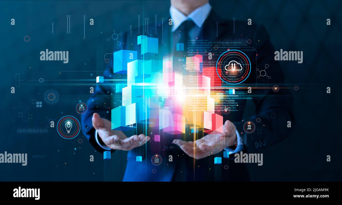 A businessman holding blockchain network and cloud computing online connecting to data ...