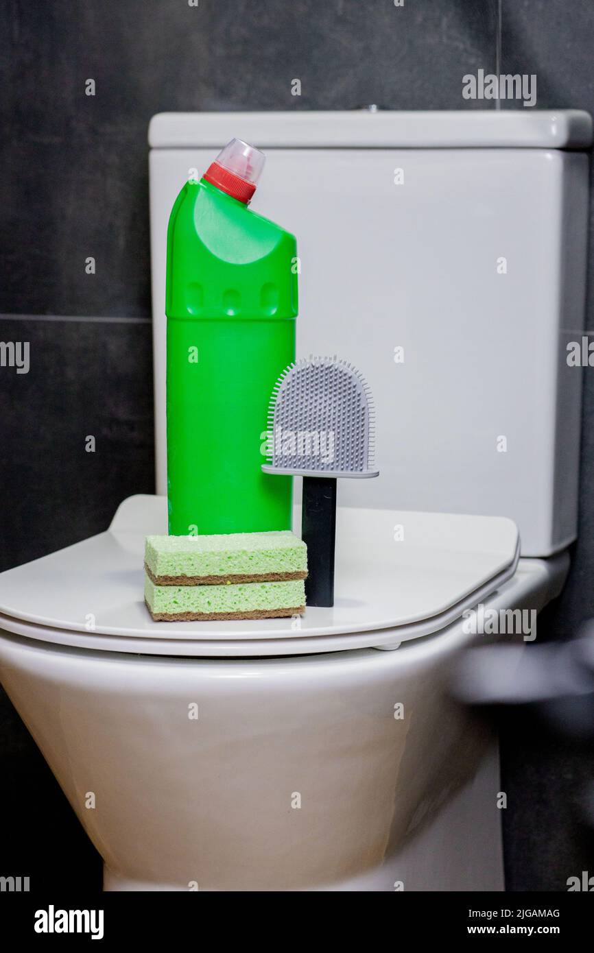 Toilet cleaner, a toilet brush and a washcloth on the toilet. Toilet ...