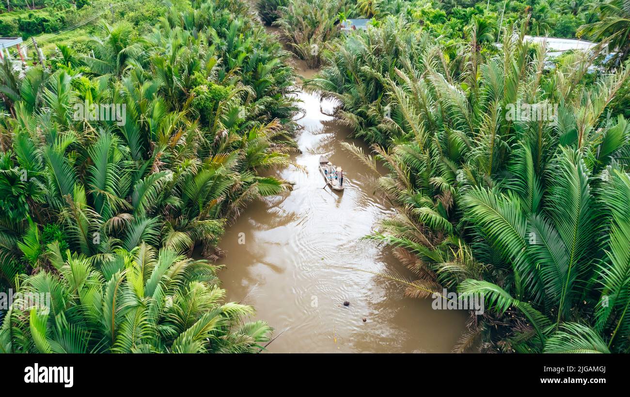 tourist on small sampan river boat cruise through mekong delta, aerial ...
