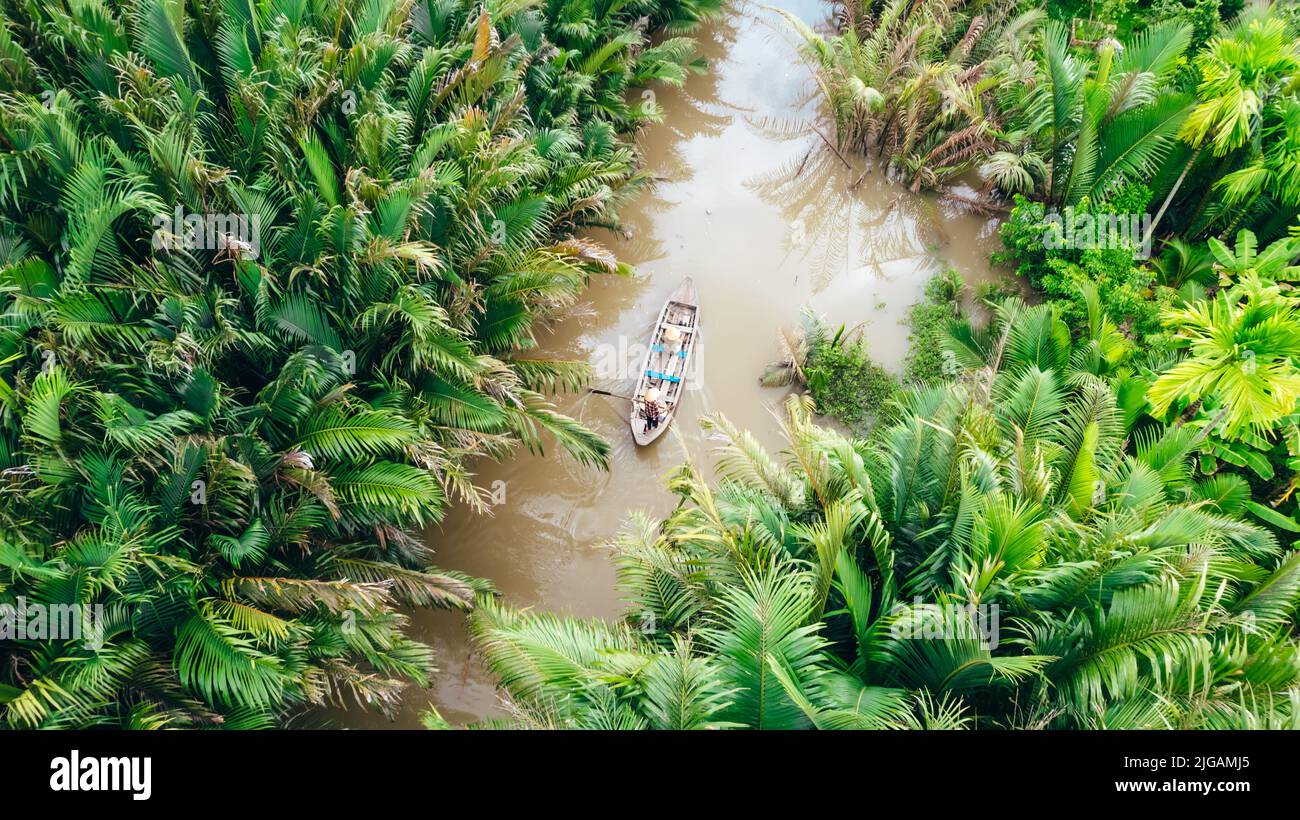 aerial top down view of sampan boat floating down river on mekong delta ...