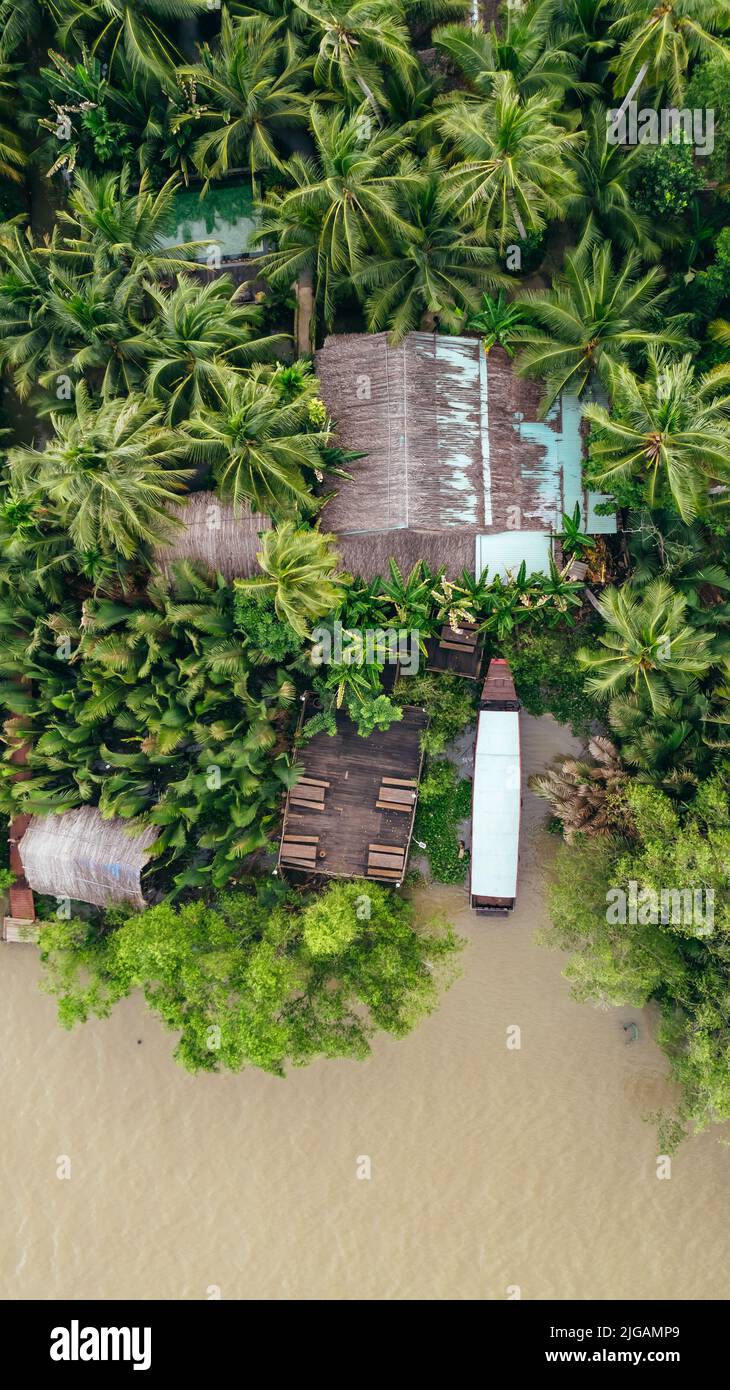 aerial top down view of pier with docked boat on the mekong delta river ...