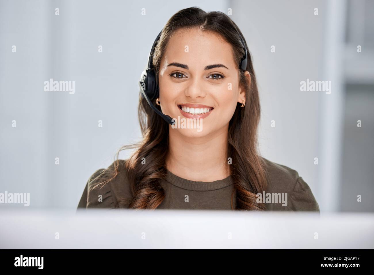 Please hold. Cropped portrait of an attractive young female call center ...