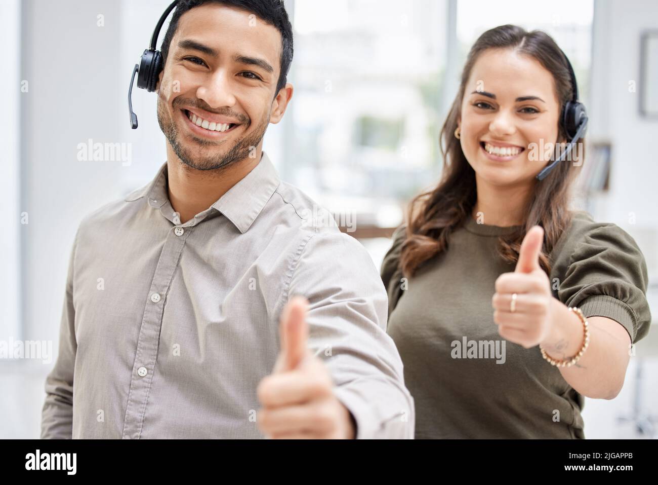 Problem solved. Cropped portrait of two young call center agents giving ... Problem solved. Cropped portrait of two young call center agents giving ...