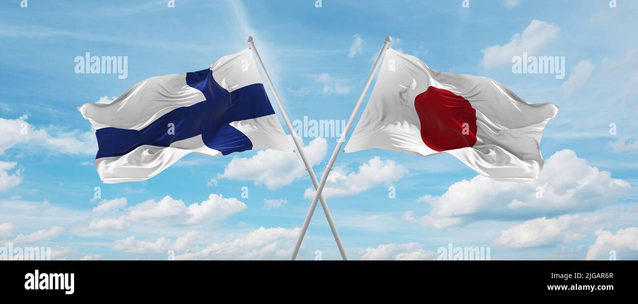two crossed flags japan and finland waving in wind at cloudy sky ...