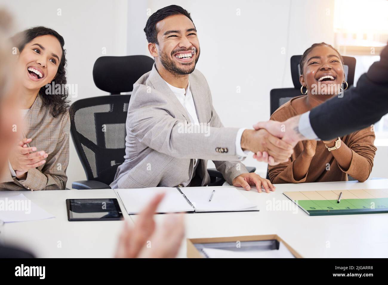 Congratulations are in order. a handsome young businessman sitting and ...