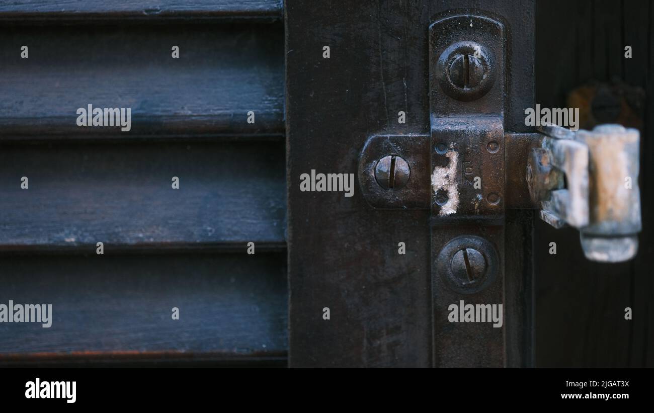 Old rustic window hinge in the village Stock Photo - Alamy