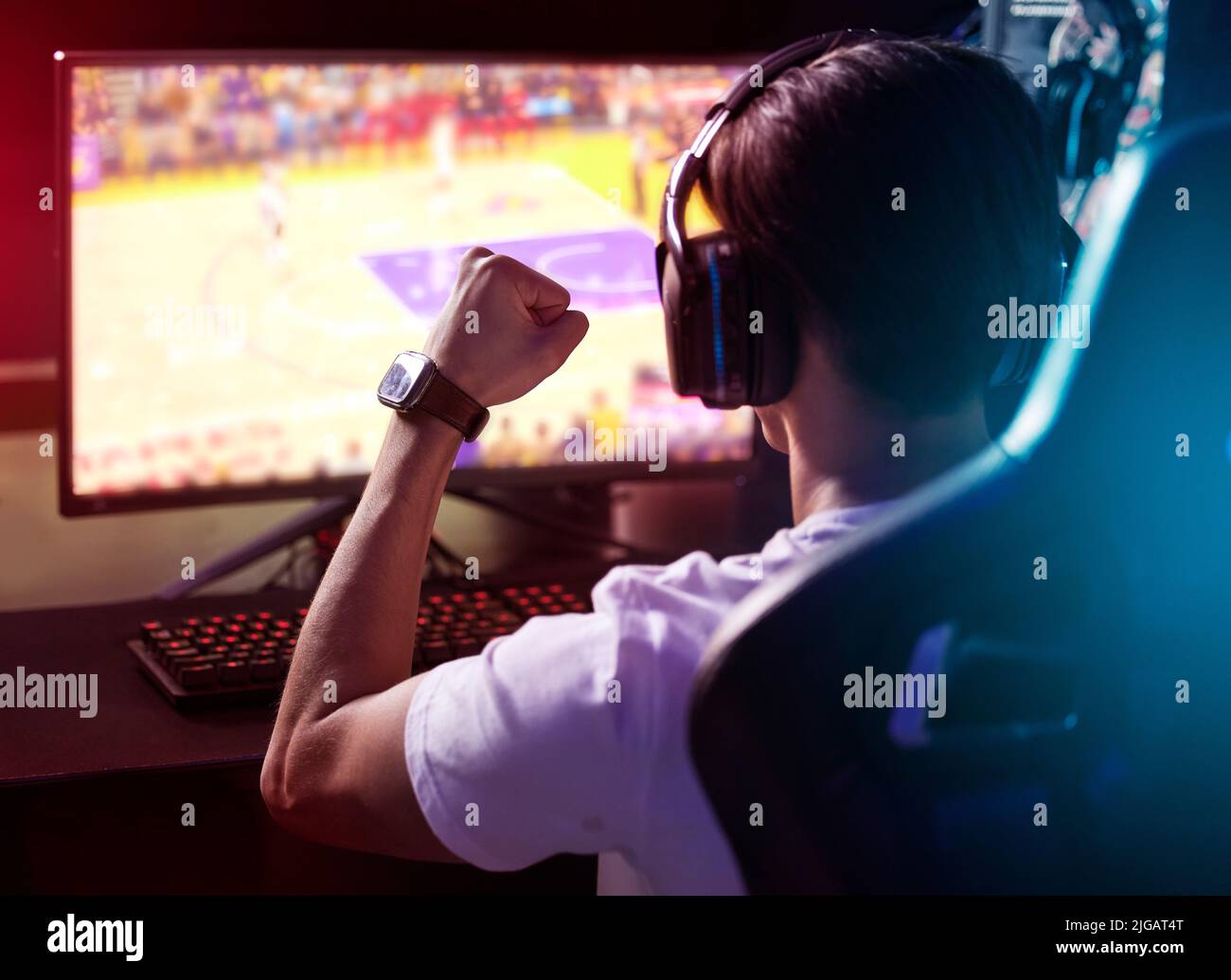 The greatest game ever. a young man cheering while playing computer ...