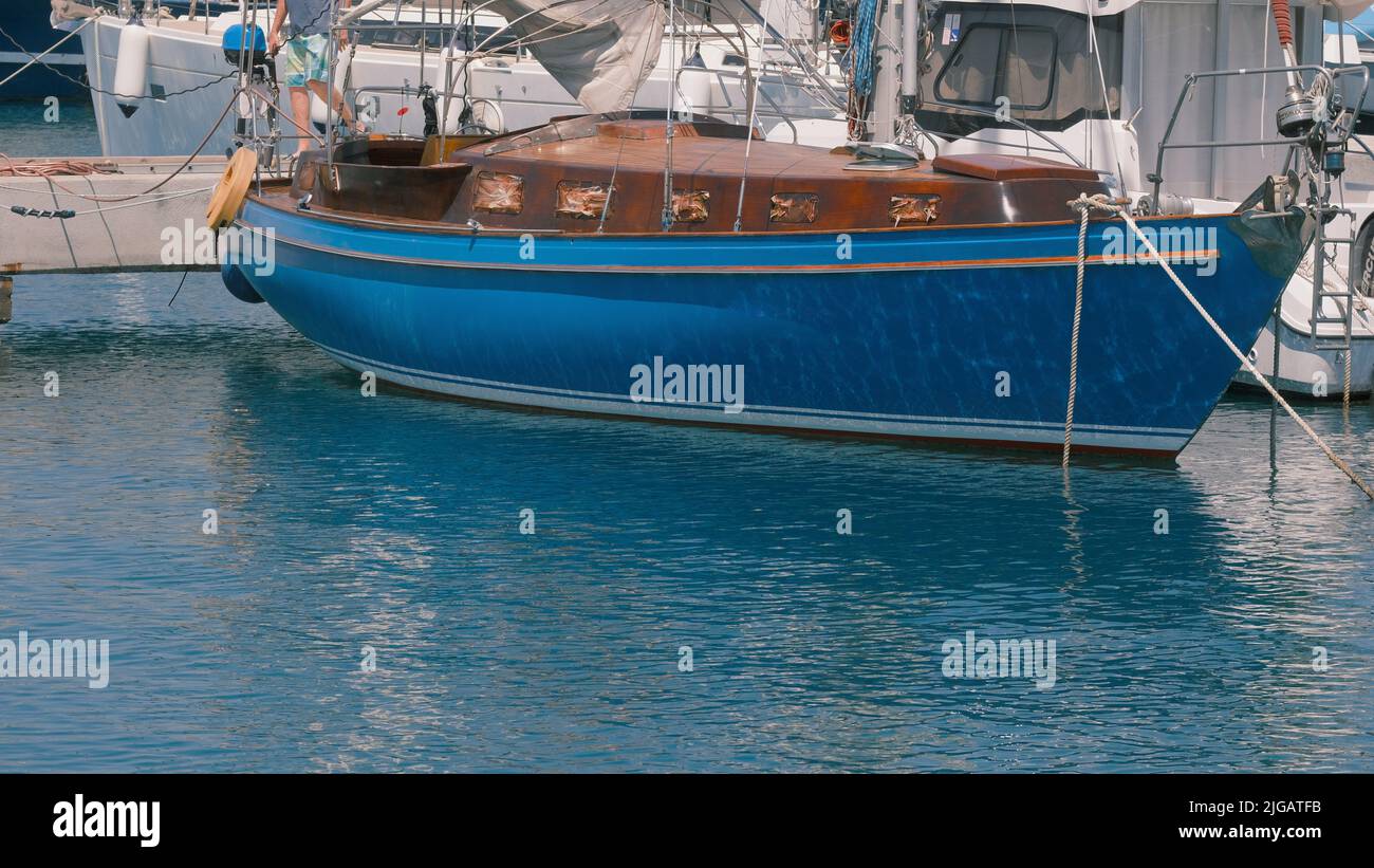 Small blue sailing yacht anchored Stock Photo - Alamy