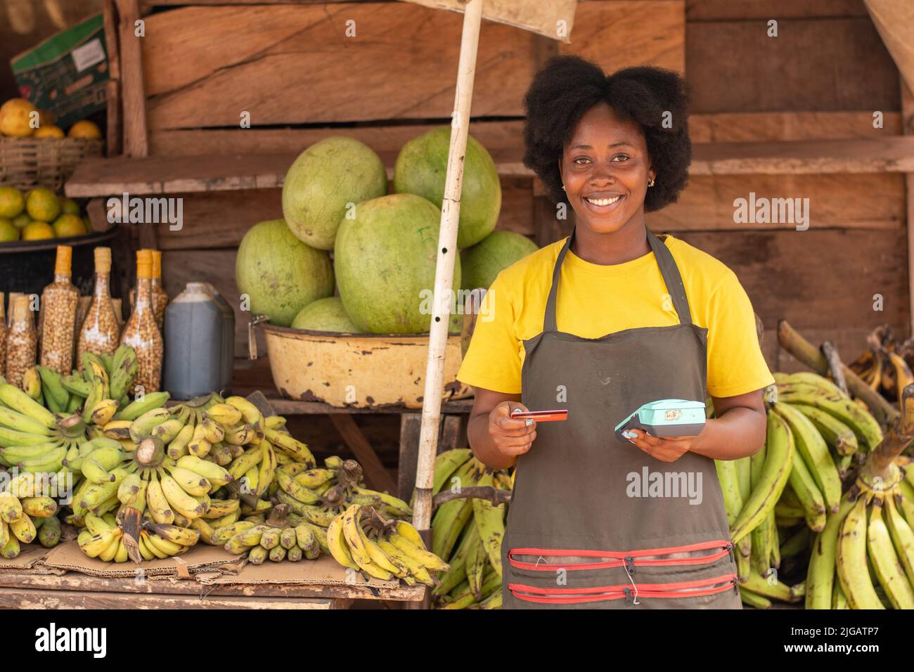 african market woman holding a pos device and a credit card Stock Photo ...