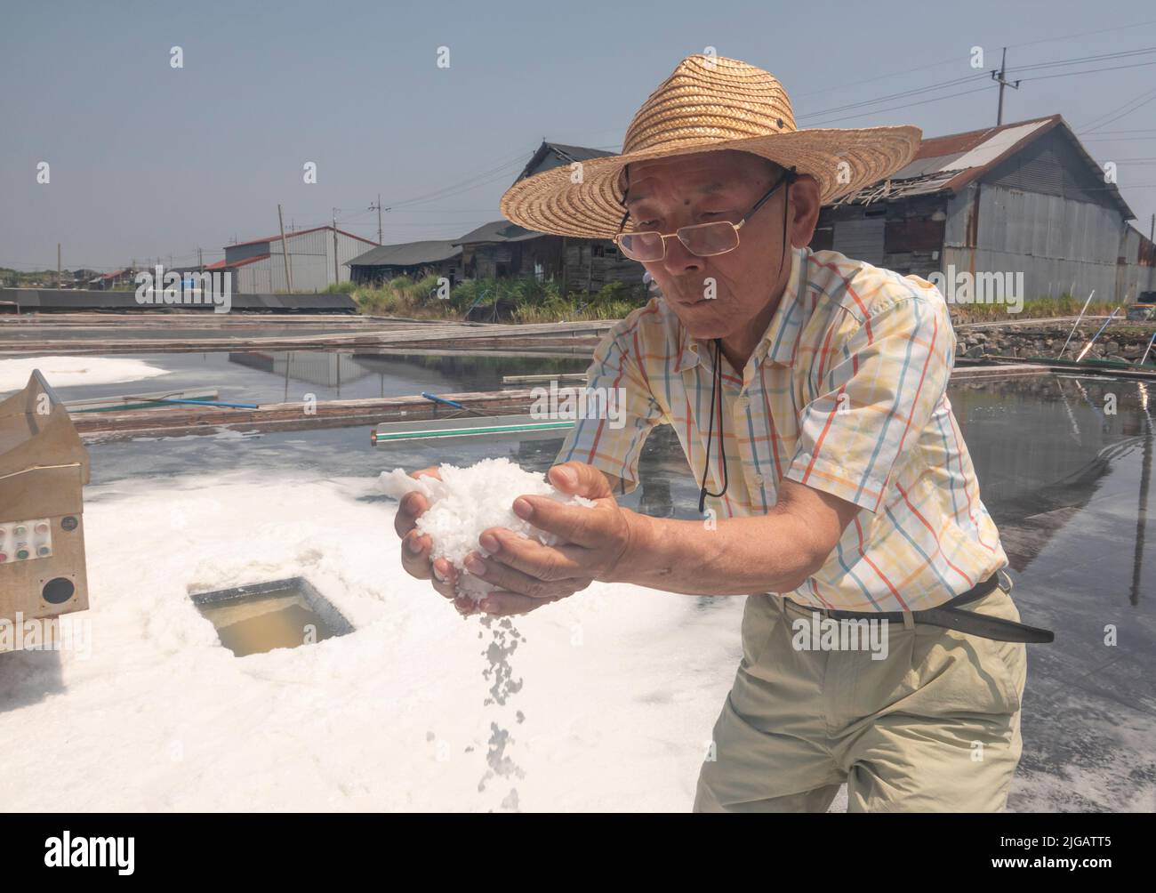 Gomso Salt Field, June 21, 2022 : The owner of Gomso Salt Field shows ...