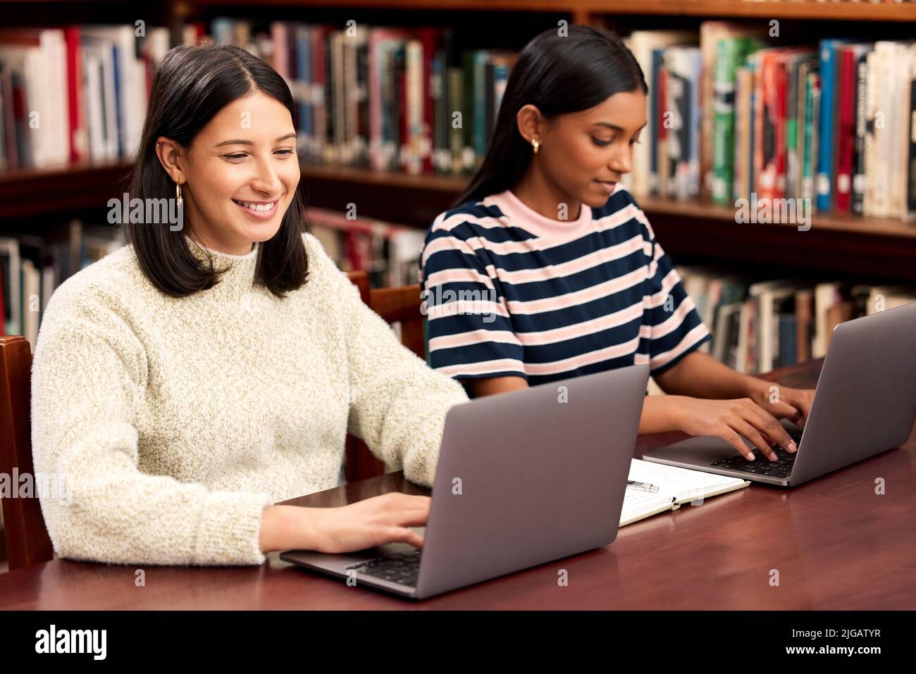 Technology helps us with our studies. two young female students ... Technology helps us with our studies. two young female students ...