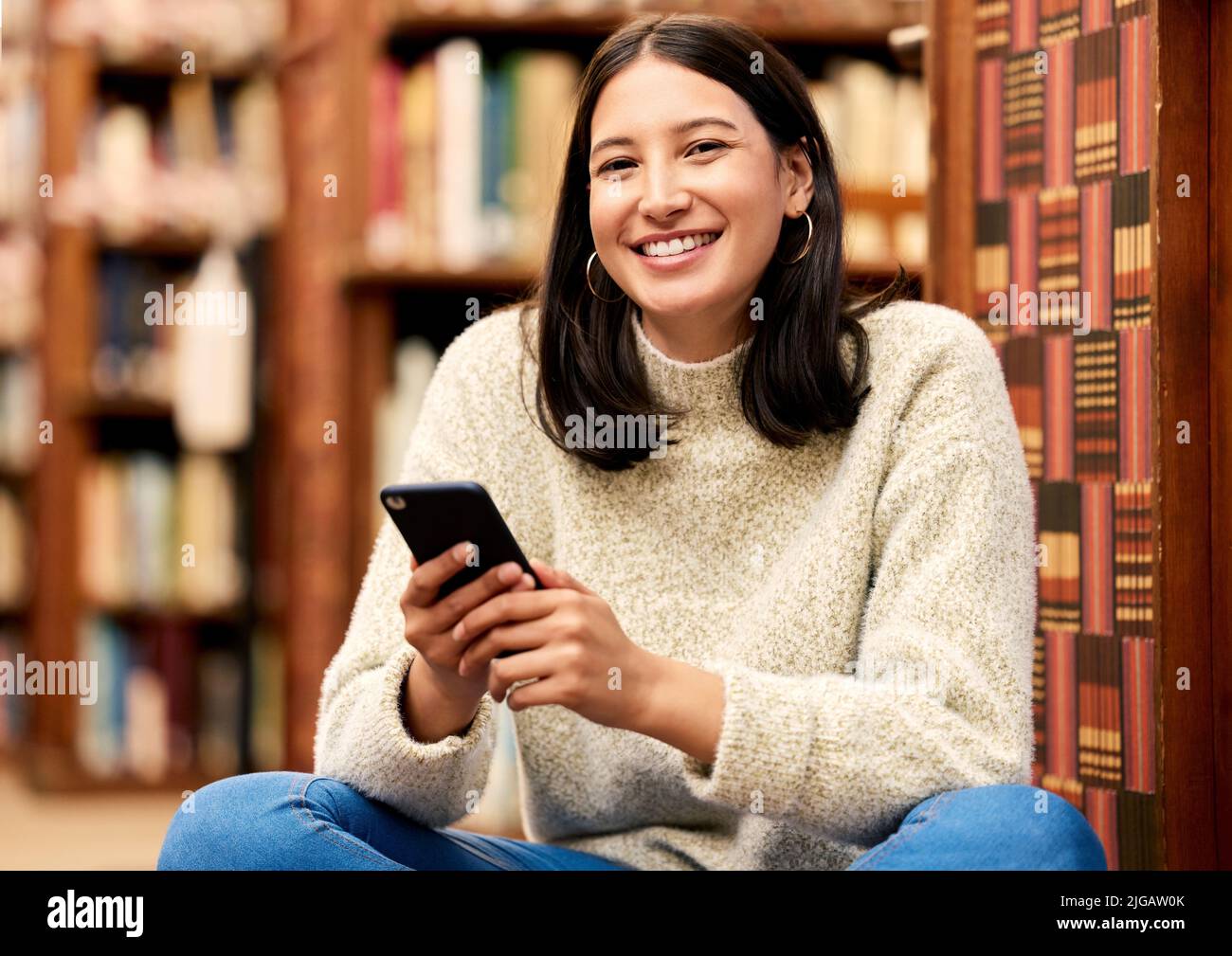 Social media has my back when Im bored. a young female student using a ...