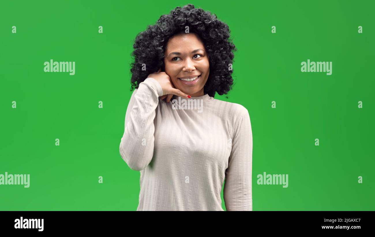The portrait of an African American lady showing call me phone sign ...