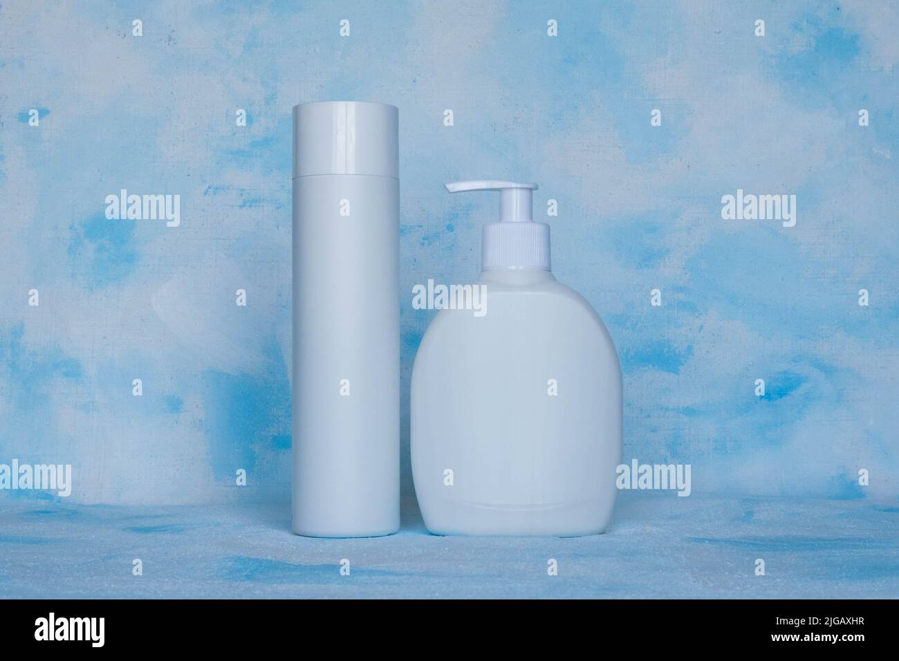 Collection of various containers for beauty hygiene on a blue and white ...