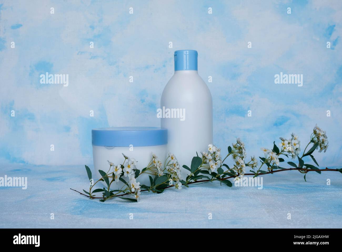 Collection of various containers for beauty hygiene on a blue and white ...