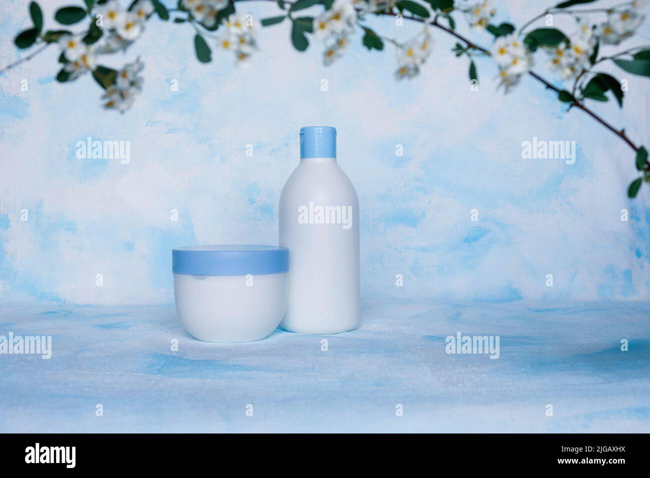 Collection of various containers for beauty hygiene on a blue and white ...