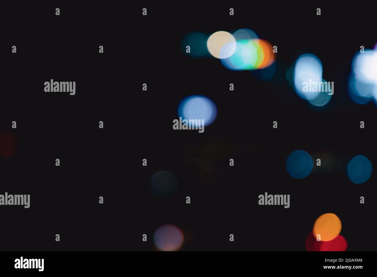 Colorful blurry light particles on a black background Stock Photo - Alamy