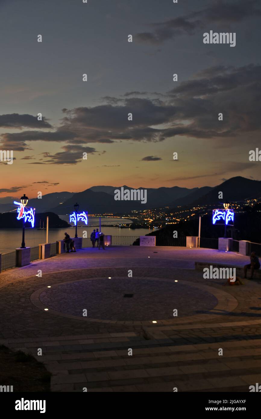 A view of dolphin decorations with lights on a shore of a sea in San ...