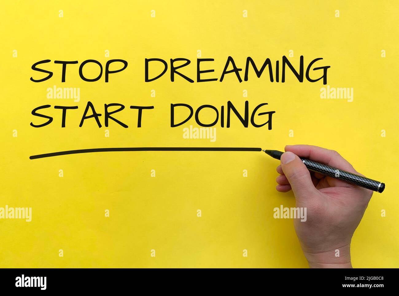 Stop dreaming start doing text on yellow background. Reality concept ...