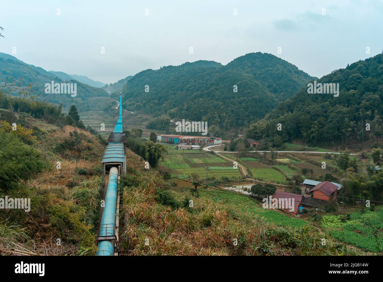 An aerial view of a water pipe and a village in a green area Stock ...
