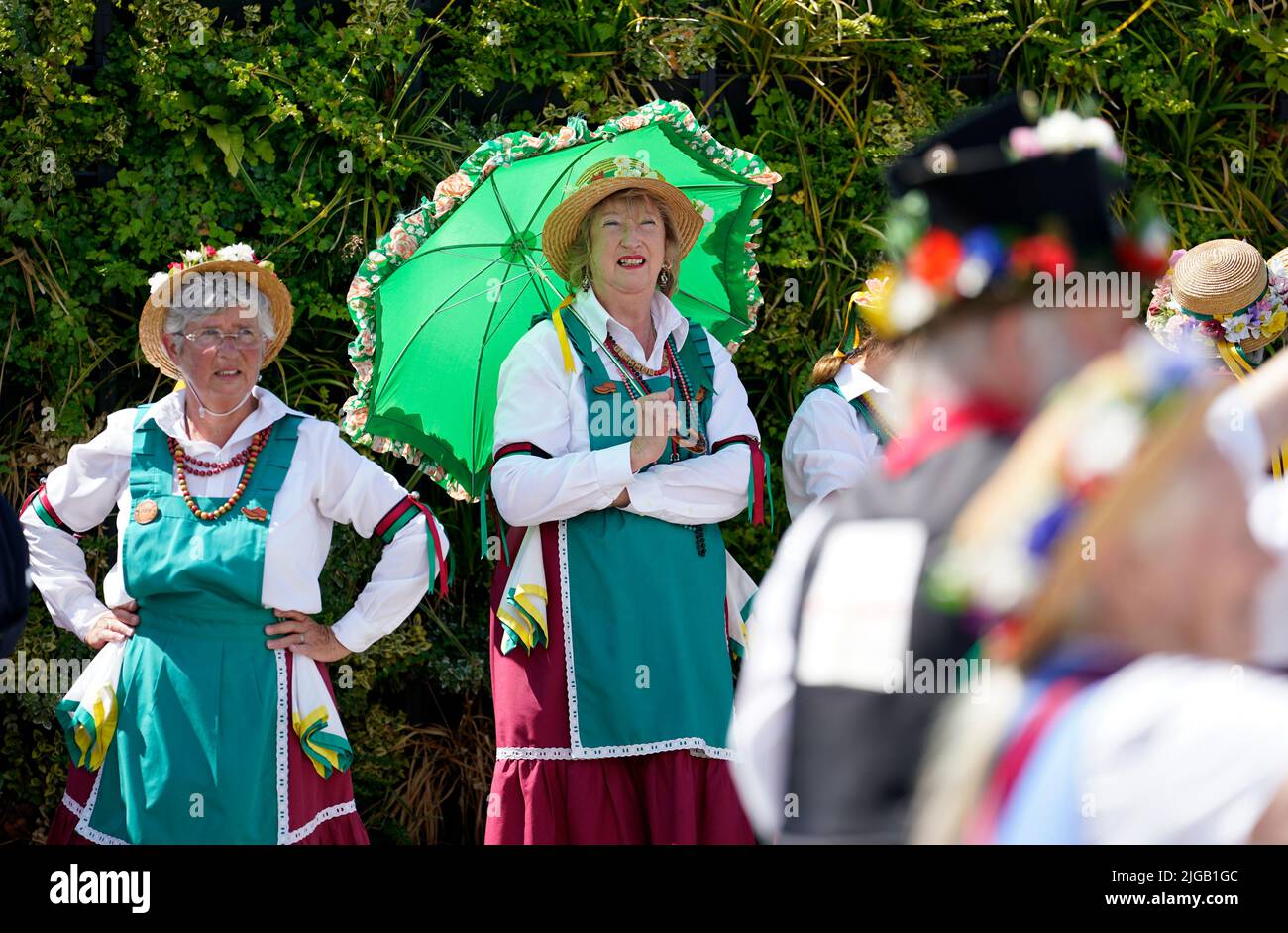 Members of Taeppa's Tump Morris look on as members of Fishbourne Mill ...
