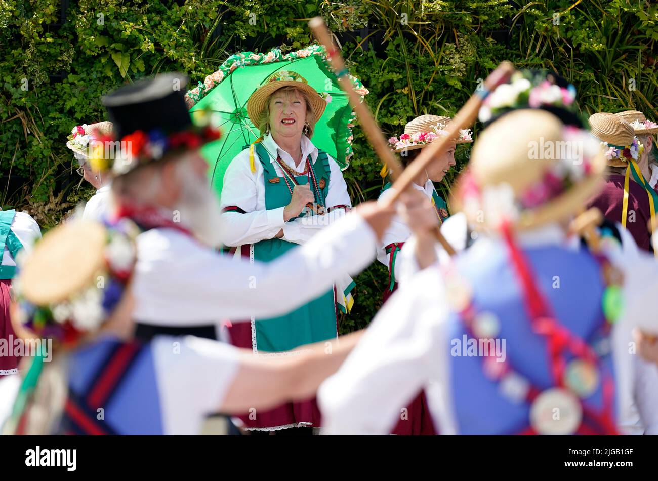 Members of Taeppa's Tump Morris look on as members of Fishbourne Mill ...