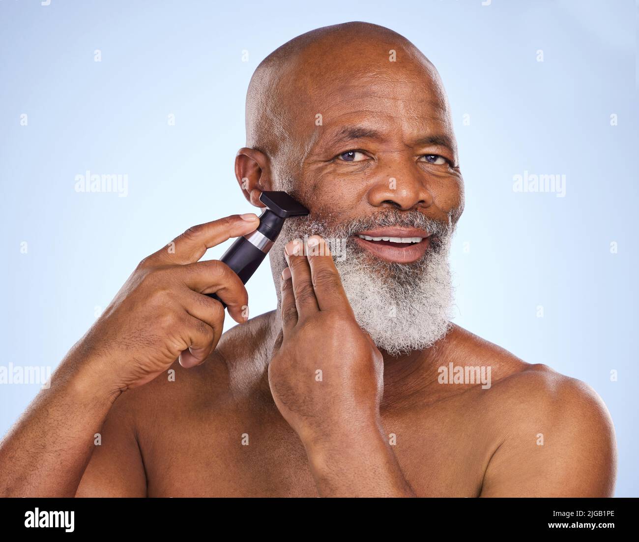 Perfected lines. Studio portrait of a mature man shaving his beard ...