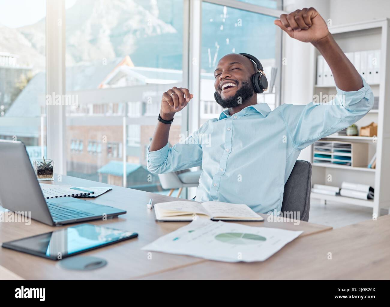 Oh yeah can you feel it. a young businessman enjoying some music while ...