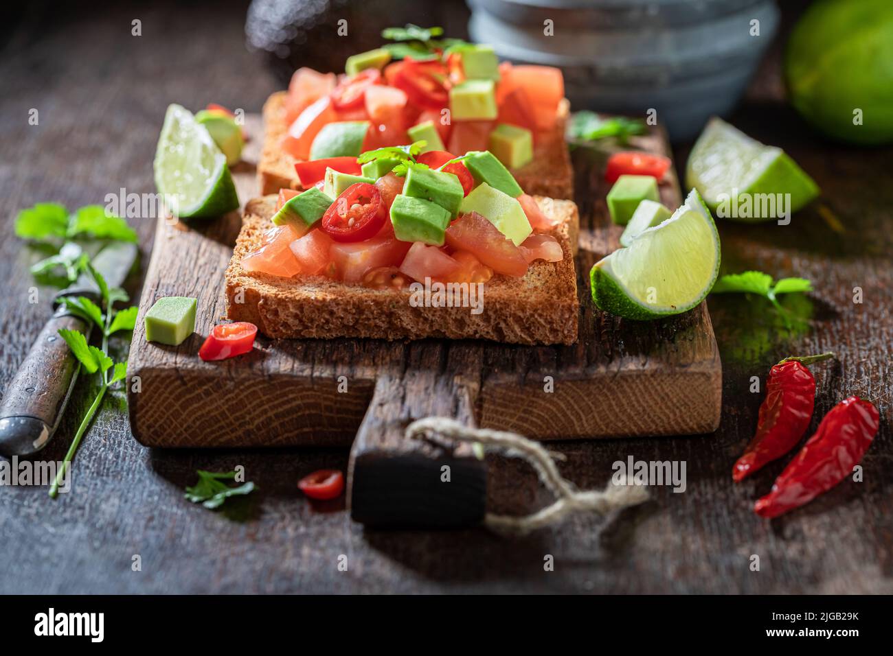 Homemade and tasty toasts with tomatoes, lime and coriander. Crunchy ...