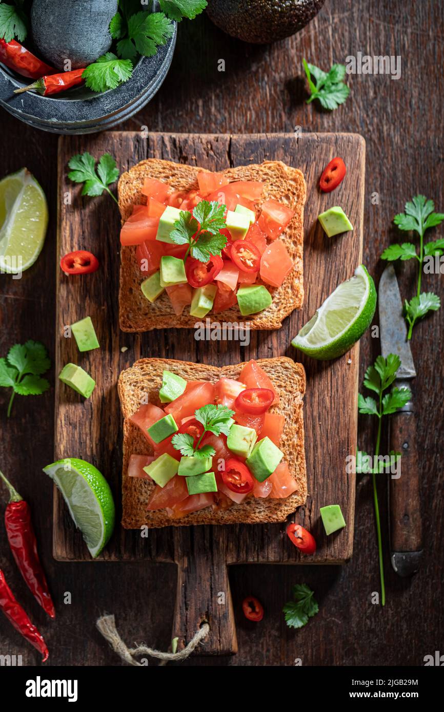 Crunchy and delicious toasts made of tomatoes, avocado and chilli ...