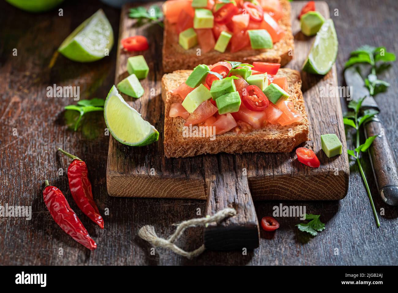 Vegetarian and hot toasts made of tomatoes, avocado and chilli pepper ...