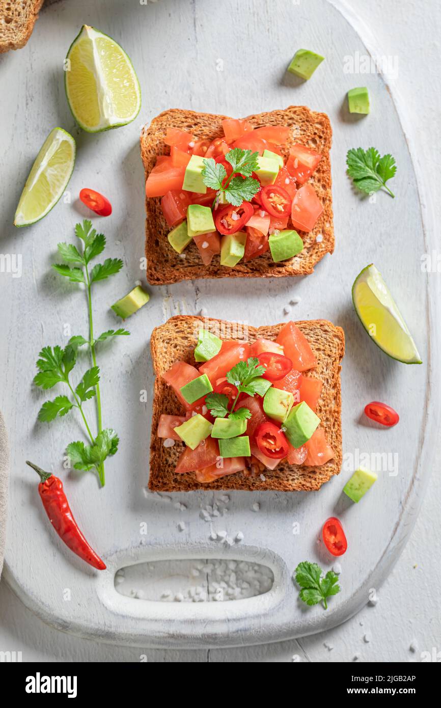 Vegetarian and hot toasts with tomatoes, lime and coriander. Toasts as ...