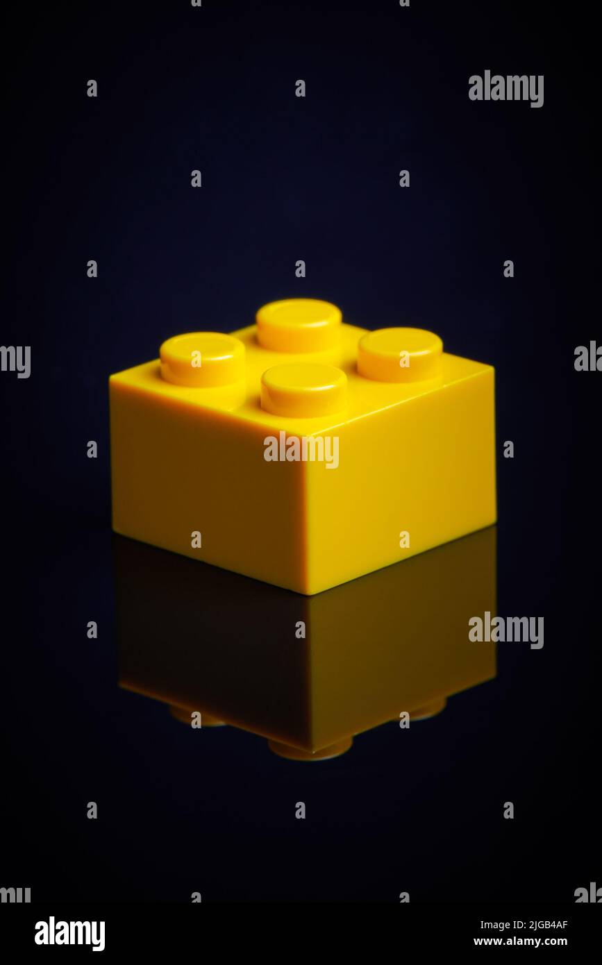 Yellow block of the designer on a black background Stock Photo - Alamy