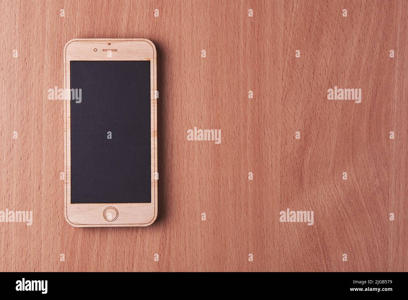 wooden smartphone on a wooden background Stock Photo - Alamy