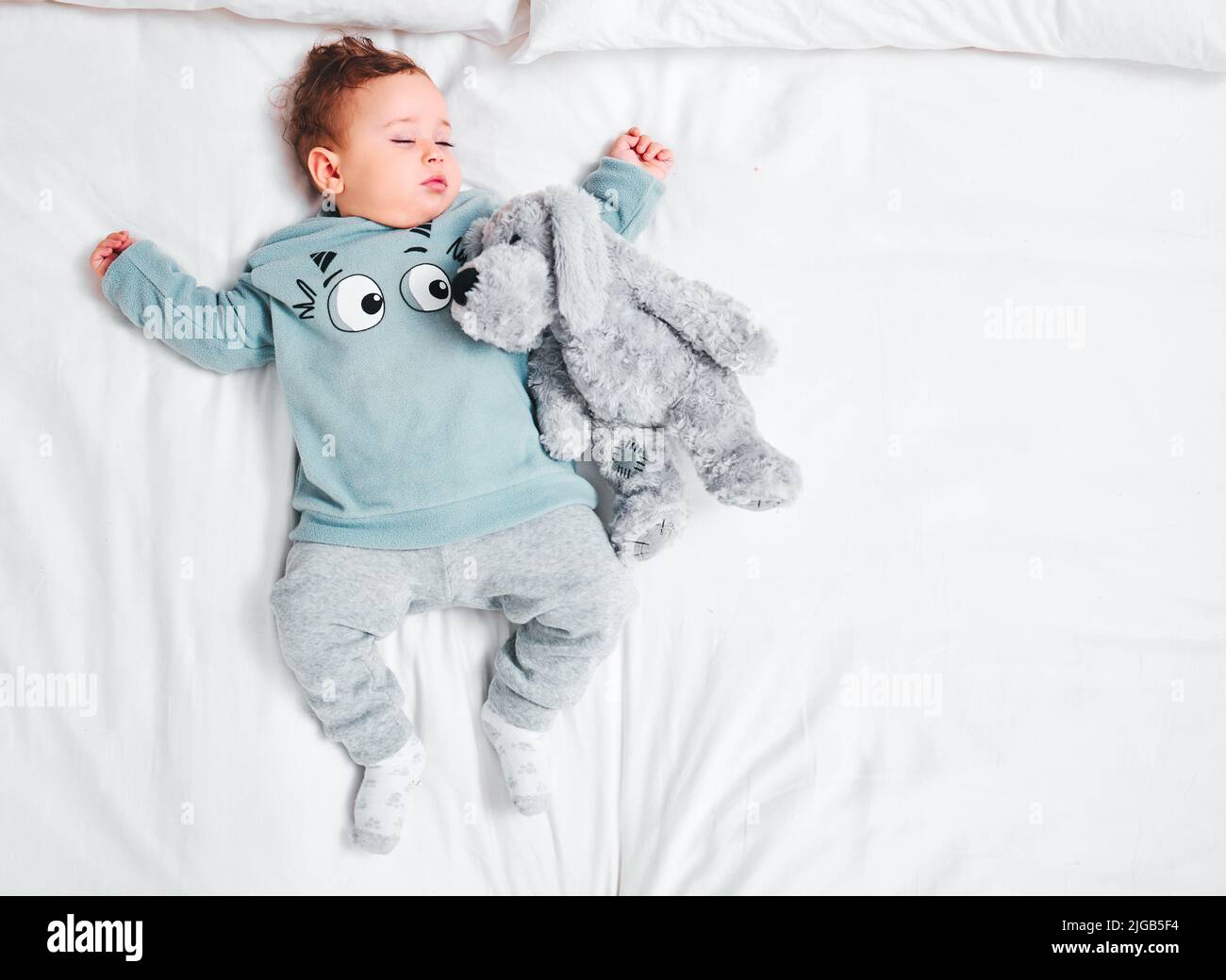 Sleeping like a baby. an adorable baby boy sleeping on a bed Stock ...