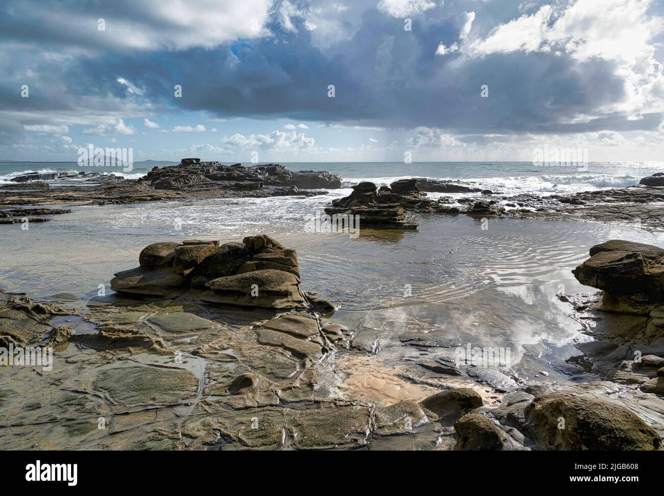 An aerial view of rocky beach in background of sea in Queensland Stock ...