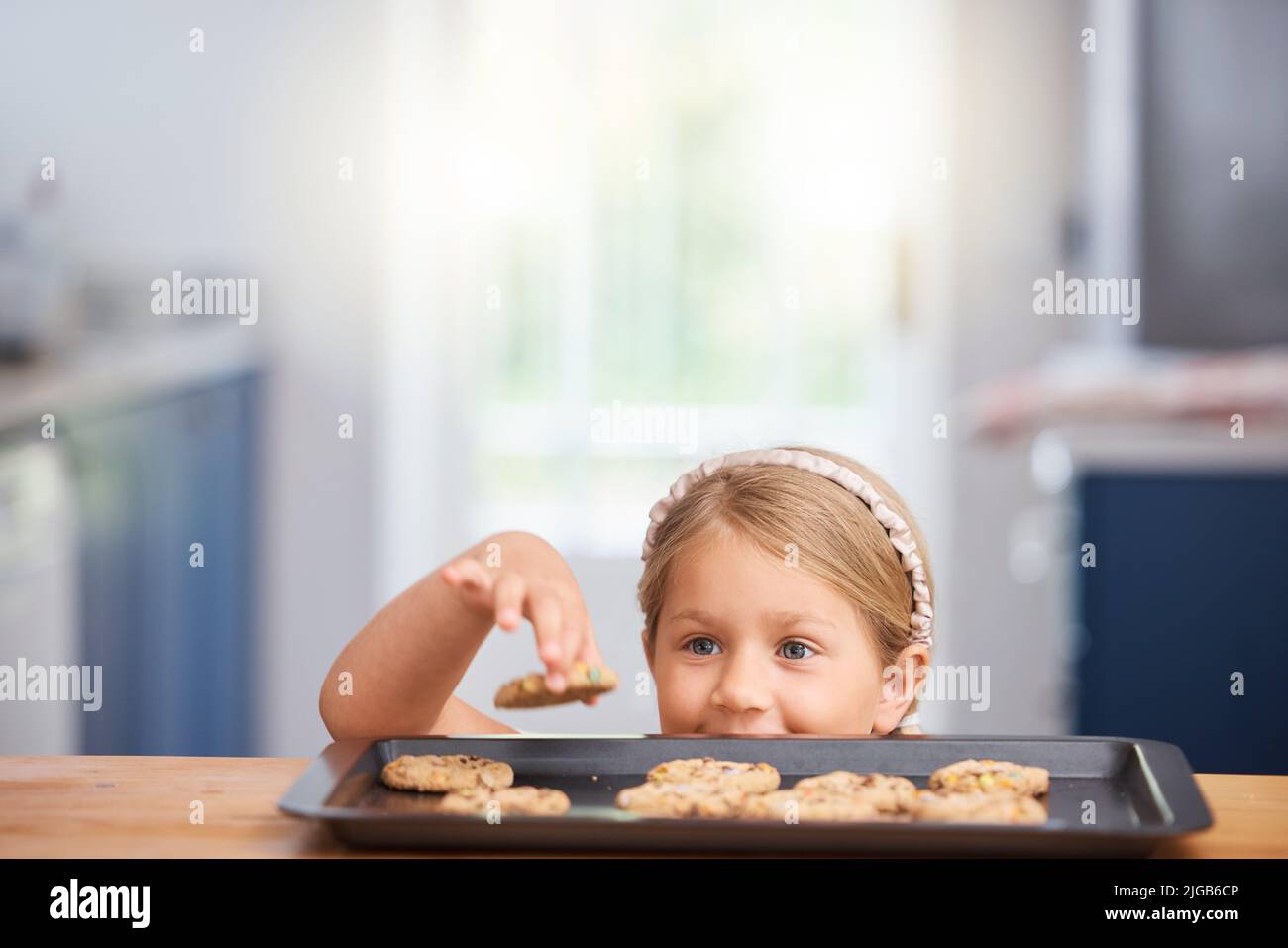 Mom wont miss this one. an adorable little girl taking a cookie from a ...